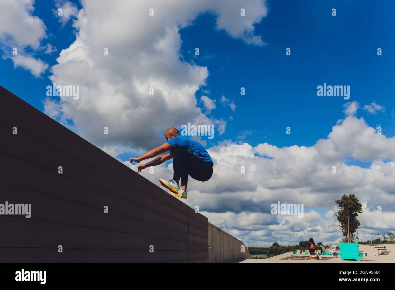 Young athlete running fast outdoors. Wearing sport cloth, doing wide ...
