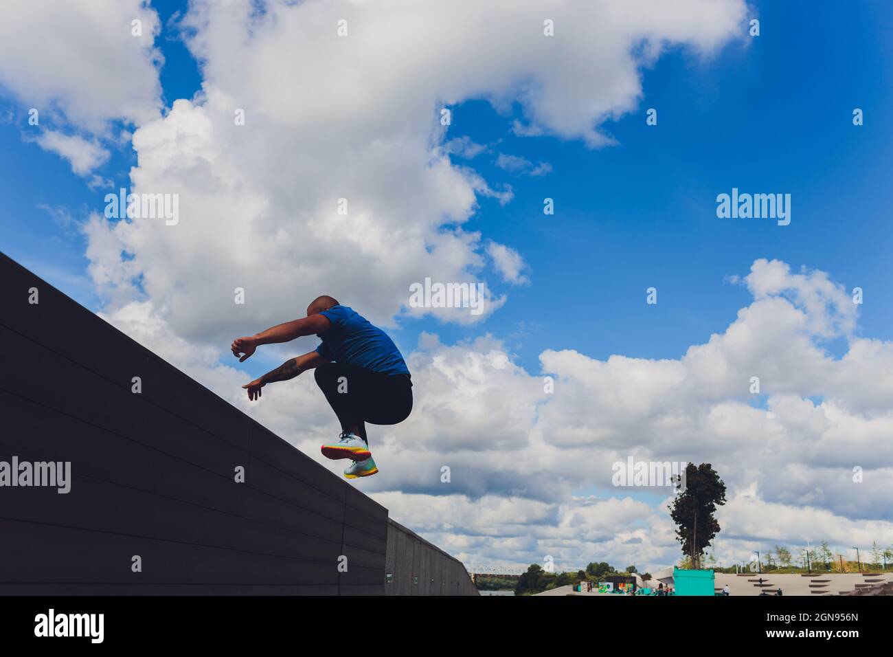 Young athlete running fast outdoors. Wearing sport cloth, doing wide ...