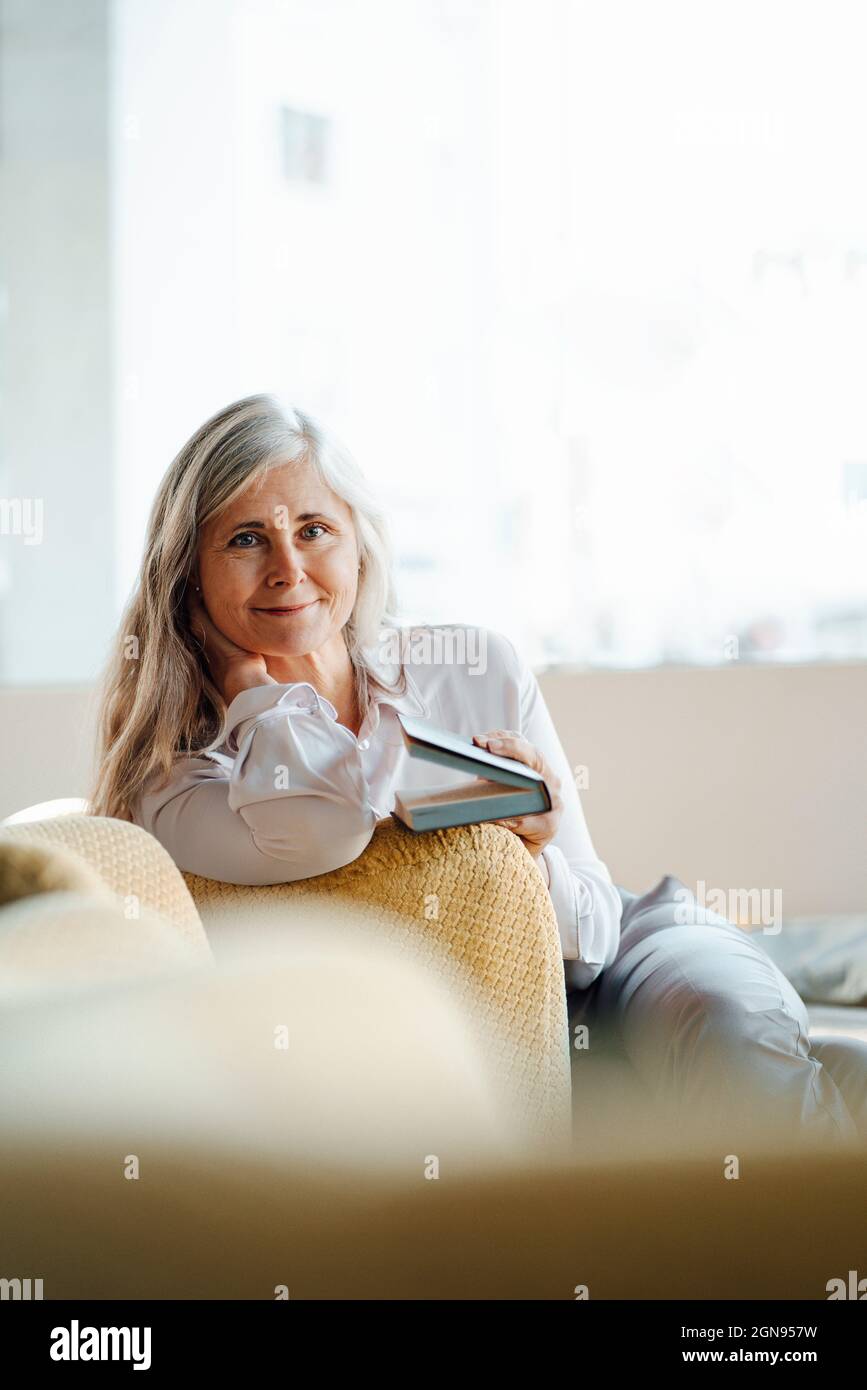 Woman leaning on chair hi-res stock photography and images - Alamy