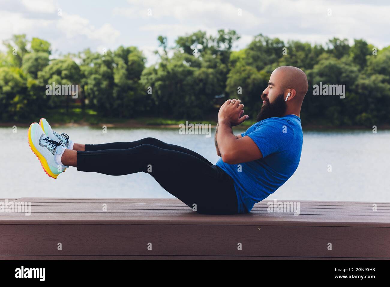 Young athlete running fast outdoors. Wearing sport cloth, doing wide ...