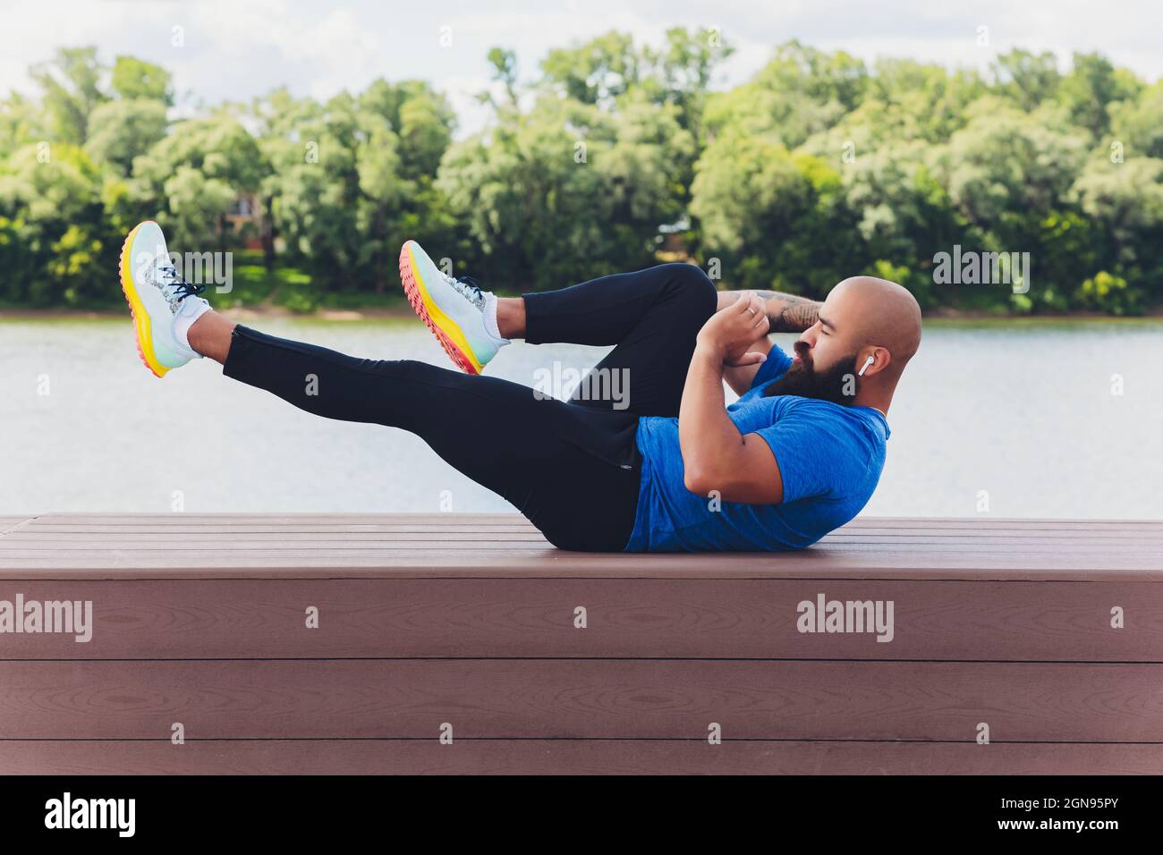 Young athlete running fast outdoors. Wearing sport cloth, doing wide ...