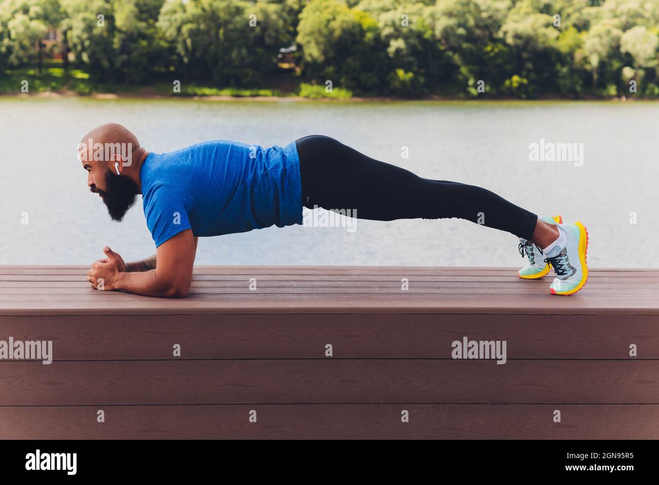 Young athlete running fast outdoors. Wearing sport cloth, doing wide ...