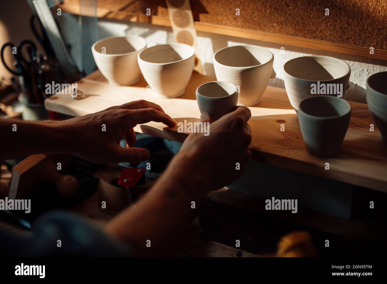 Female artist designing cup while working at home office Stock Photo ...