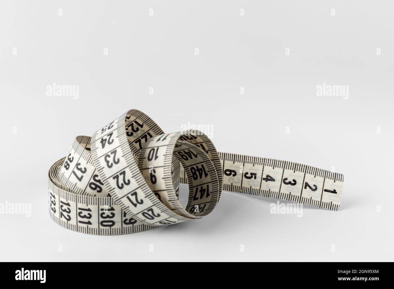 soft two sided tape measure roll isolated on a white and gray ...