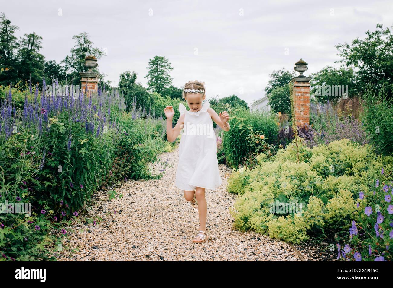 flower girl dancing at a wedding in a beautiful flower garden Stock ...
