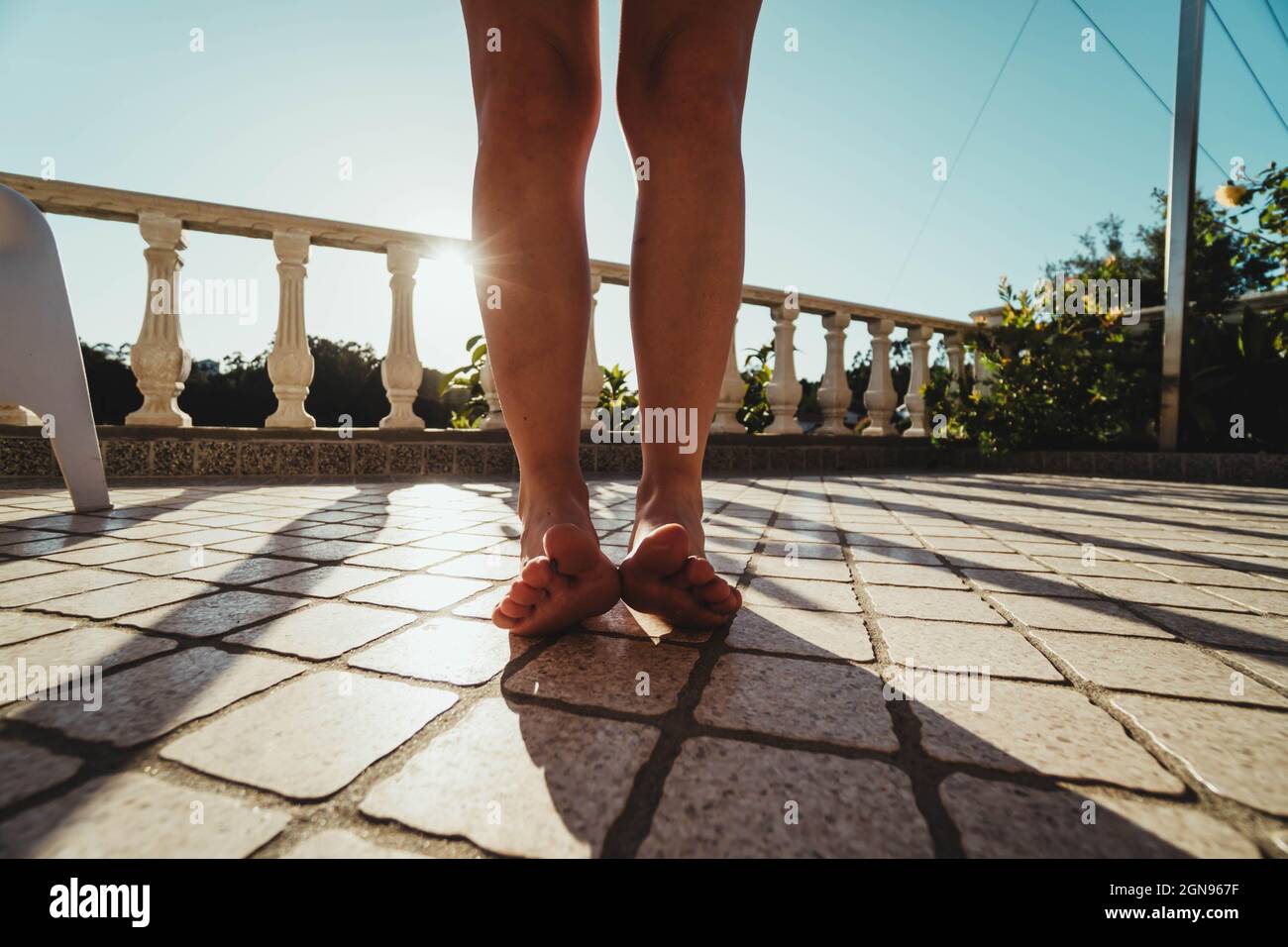 Woman's feet and legs against sunset sun and blue sky Stock Photo - Alamy