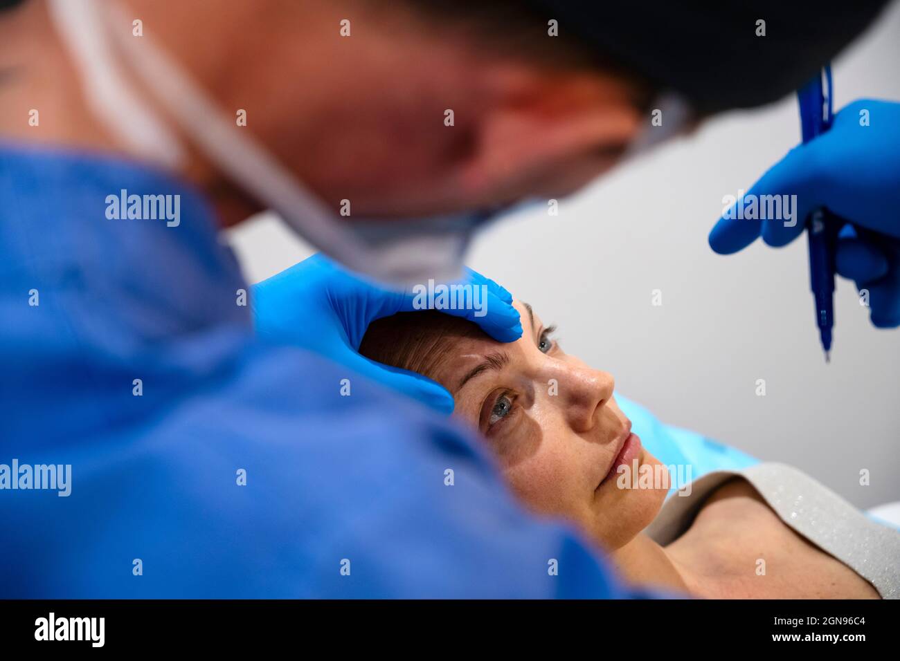 Plastic Surgeon Examines Beautiful Woman's Face Stock Photo - Alamy