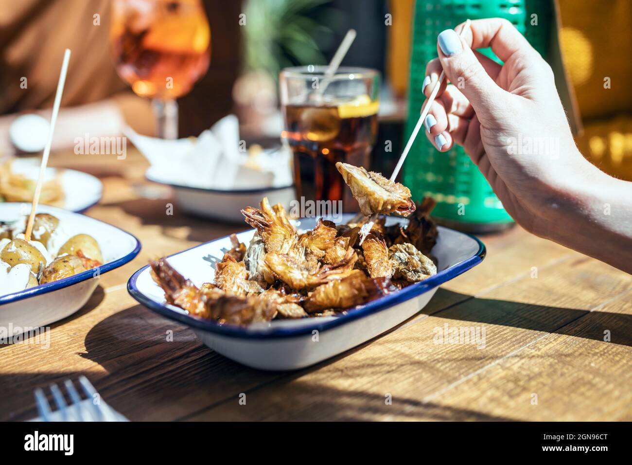 Woman having fried prawn in restaurant Stock Photo - Alamy