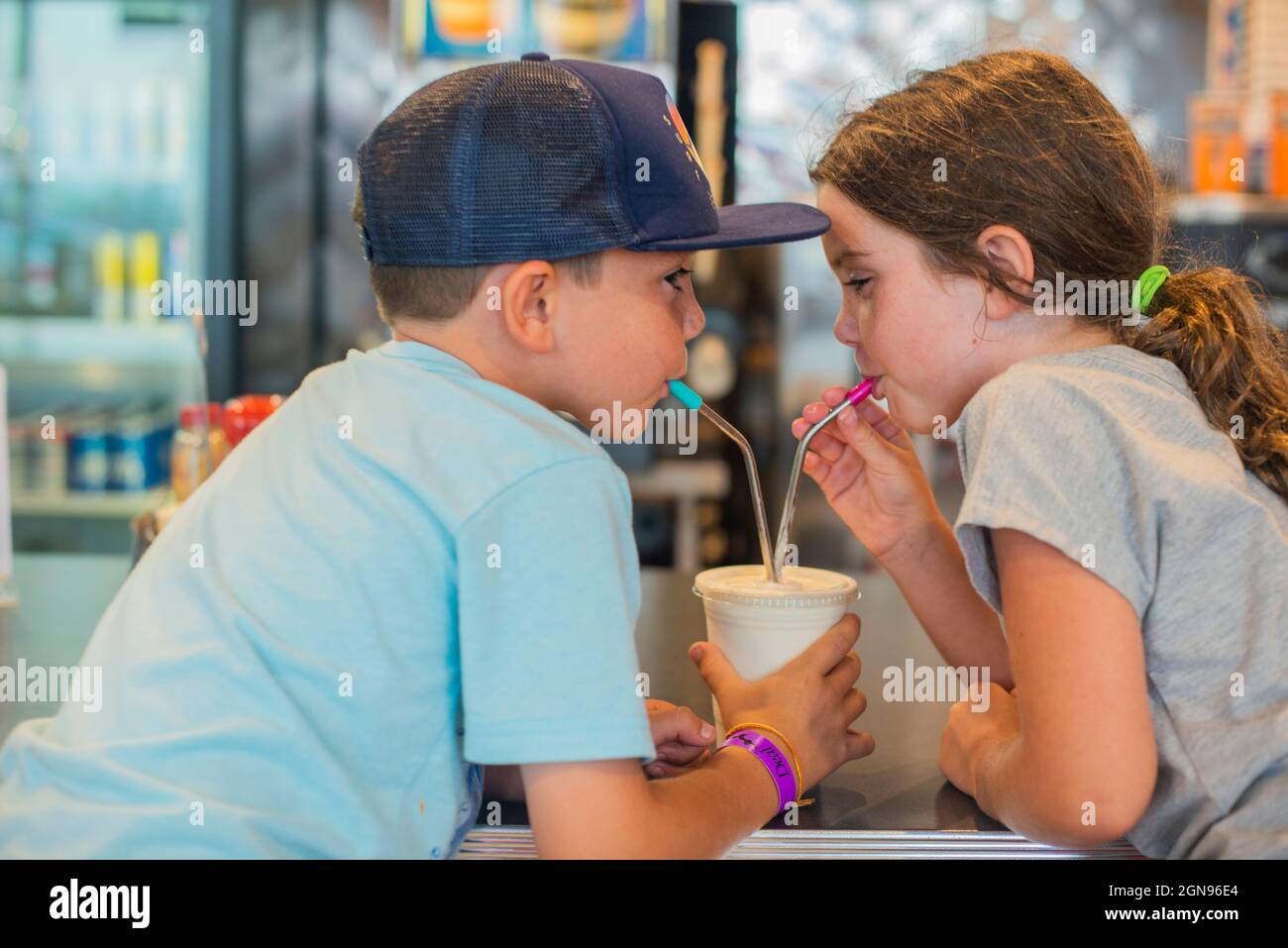 Twins sharing a Milkshake at a diner Stock Photo - Alamy