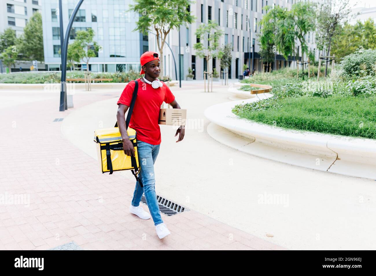 Young delivery man walking hi-res stock photography and images - Alamy