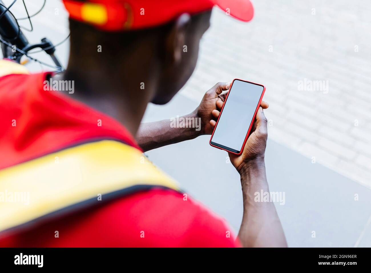 Delivery man using mobile phone Stock Photo - Alamy