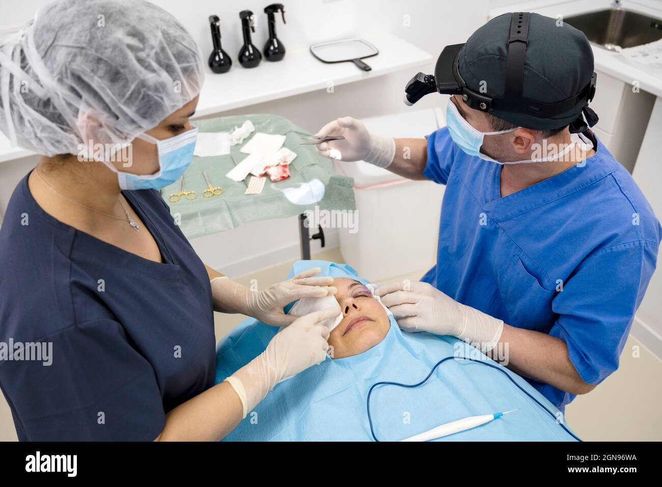 Surgeon sutures the eyelid after plastic surgery operation Stock Photo ...