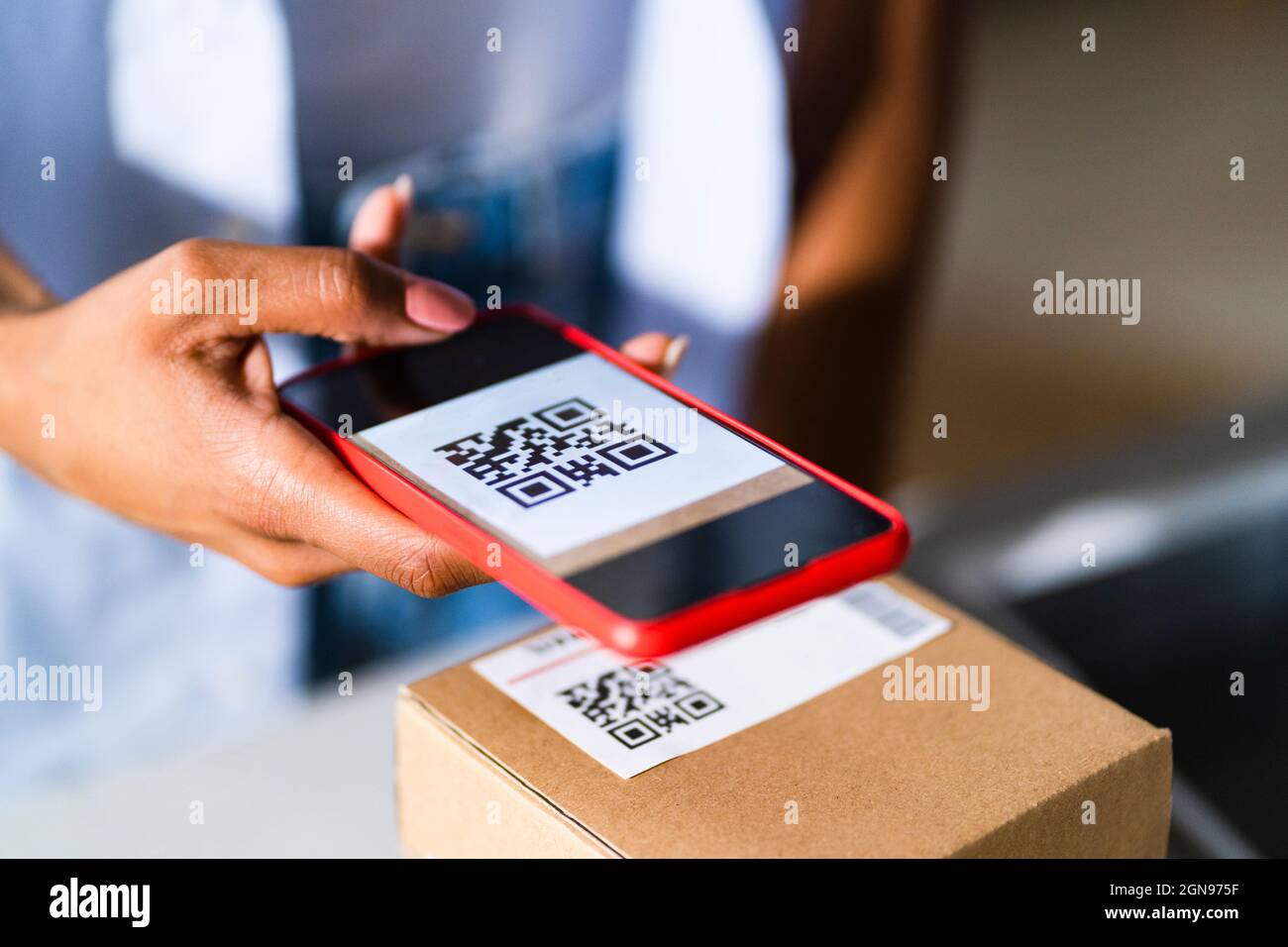 Young businesswoman scanning barcode through mobile phone Stock Photo ...