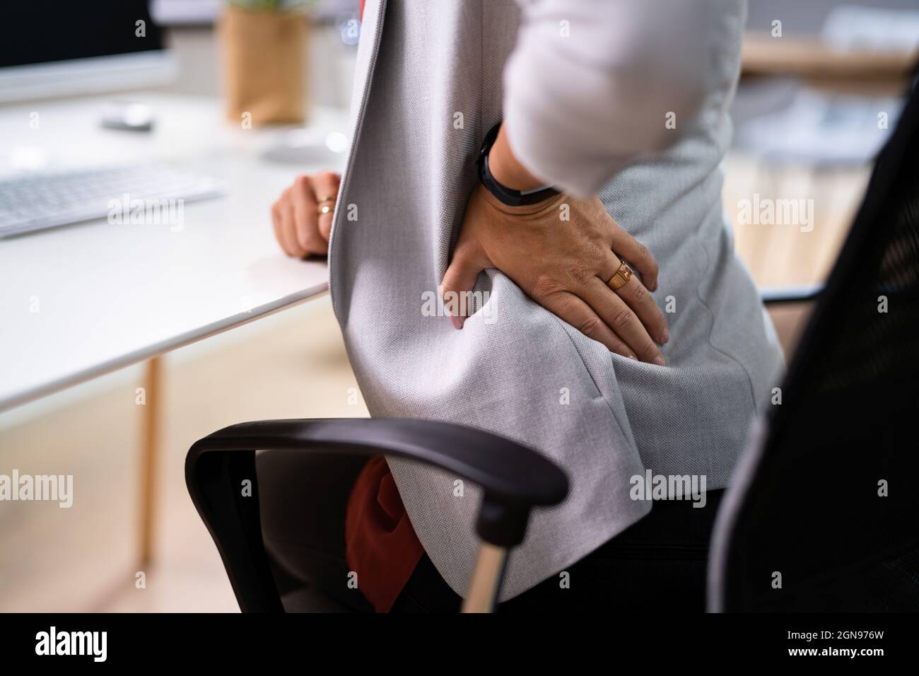 Back Pain Bad Posture Woman Sitting In Office Stock Photo - Alamy