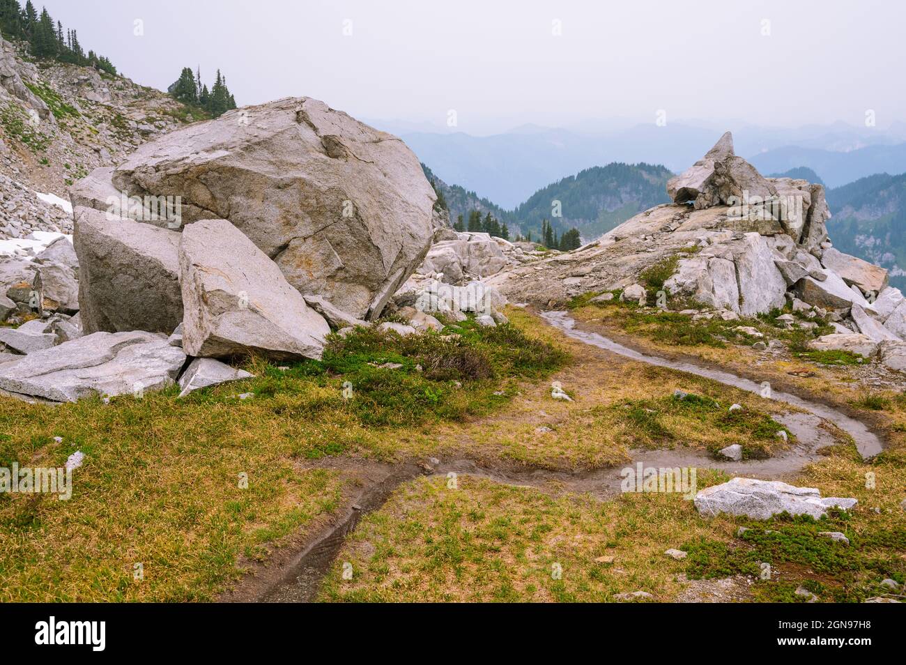 Trail bending through two granite boulders in the alpine Stock Photo ...