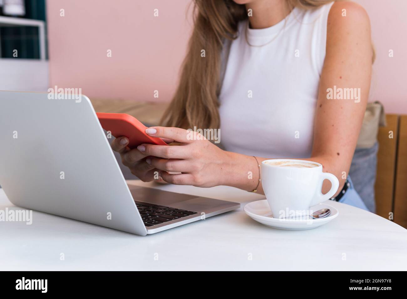 Businesswoman with laptop using mobile phone in coffee shop Stock Photo ...