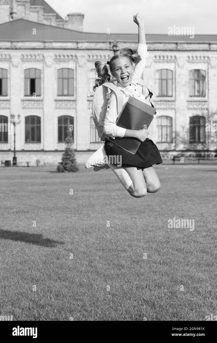 Spare time. Energetic kid jump in schoolyard. School holidays. Happy ...