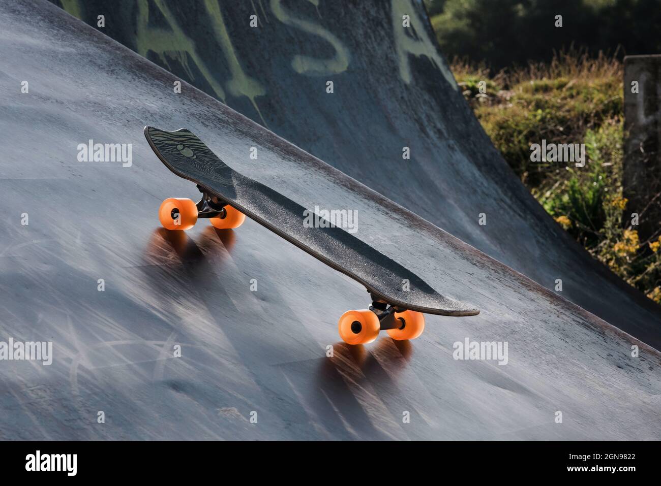 skateboard rolling down a ramp at a skatepark in the UK Stock Photo - Alamy