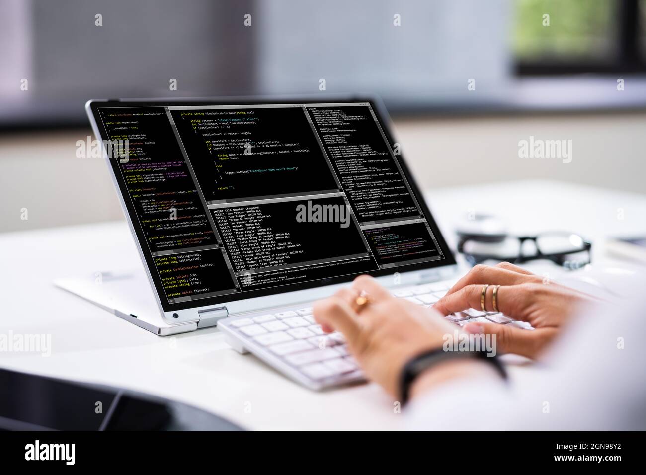 Programmer Or Coder At Office Desk Using Laptop Stock Photo - Alamy