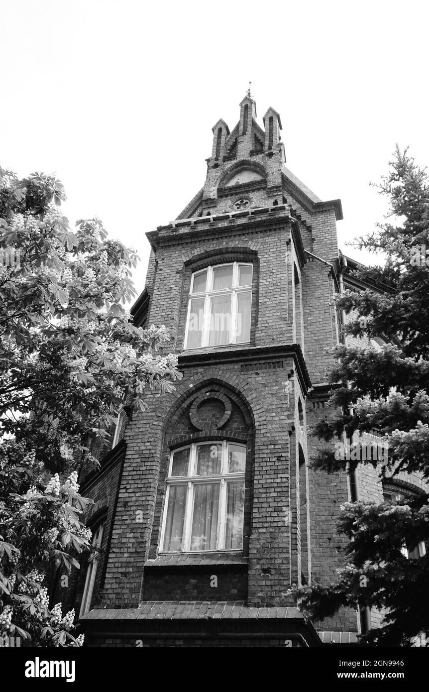 Vertical grayscale shot of a tower of a brick building Stock Photo - Alamy