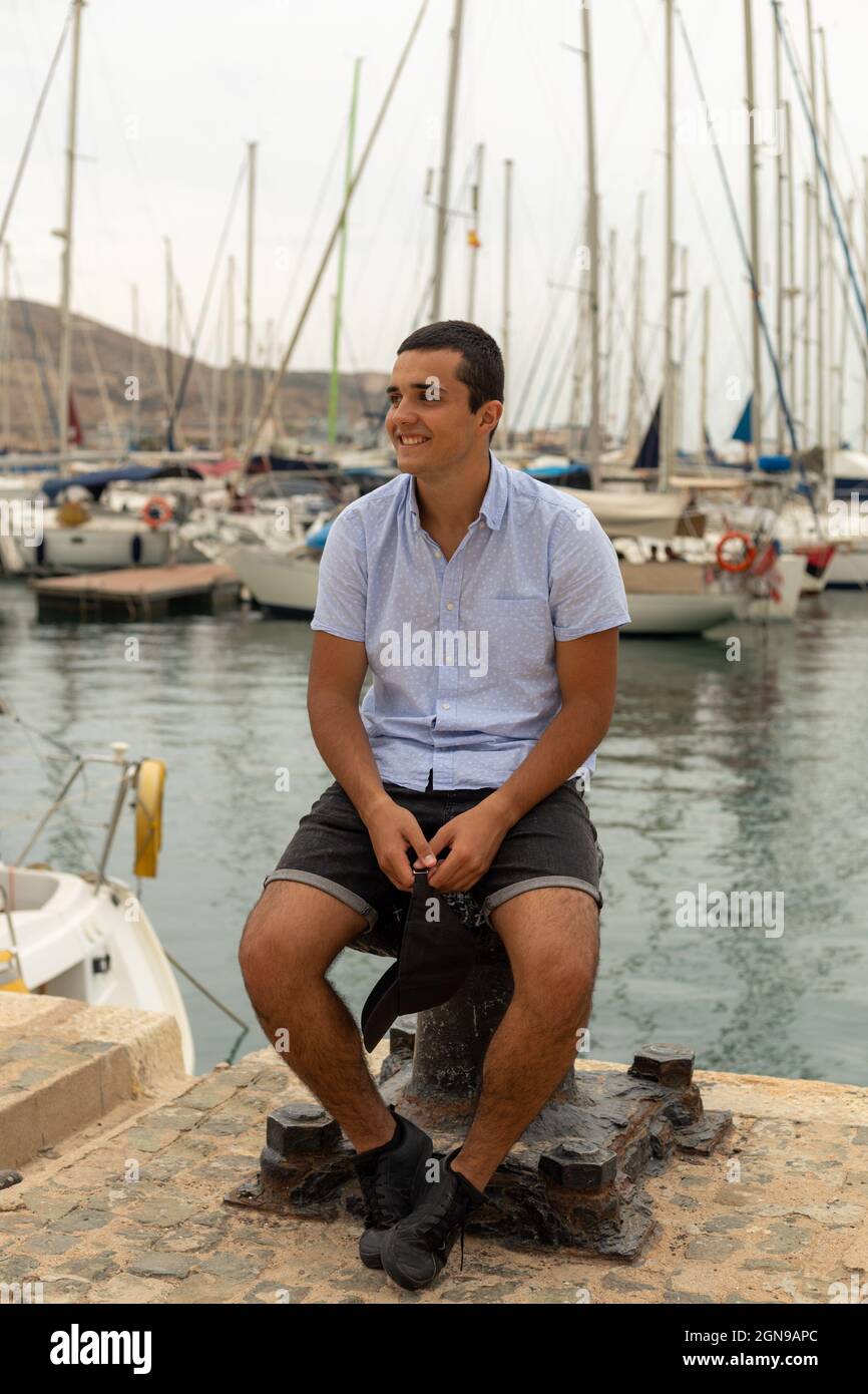 Man sitting on dock hi-res stock photography and images - Alamy