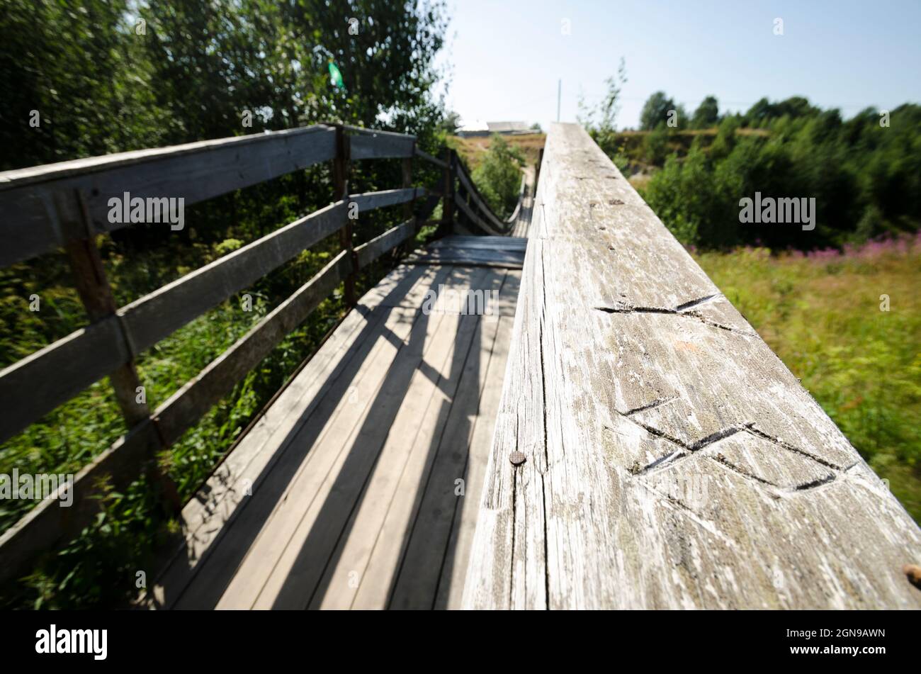 Wooden suspension bridge with runes on the railing Stock Photo - Alamy