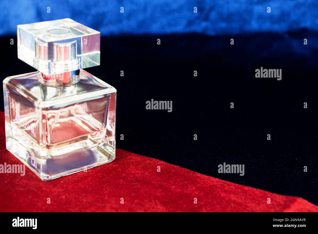 A mock-up of a perfume bottle on a dark background. Side view Stock ...