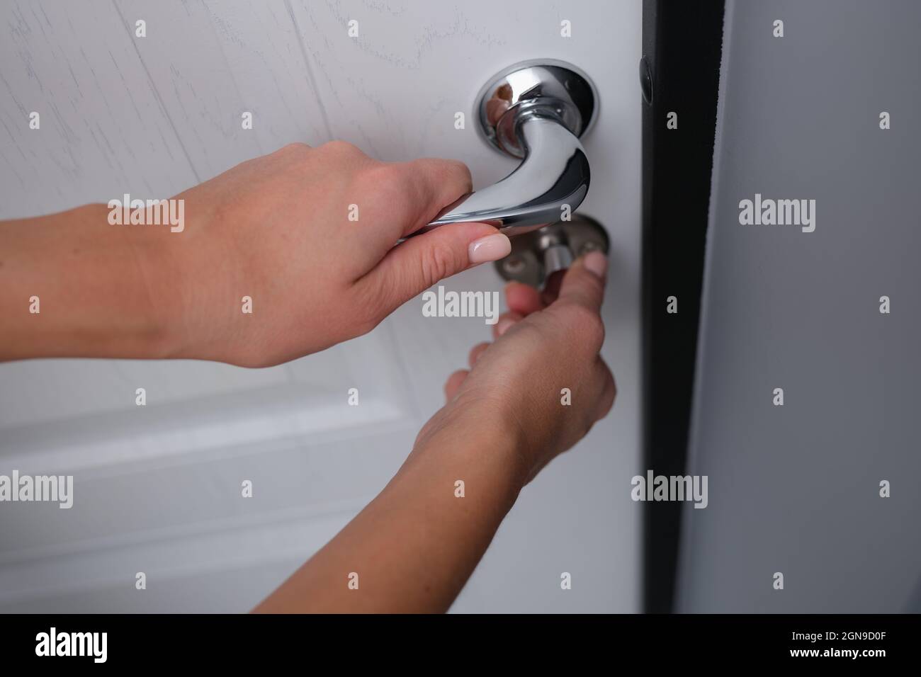 Door lock is opened by woman hand closeup Stock Photo - Alamy