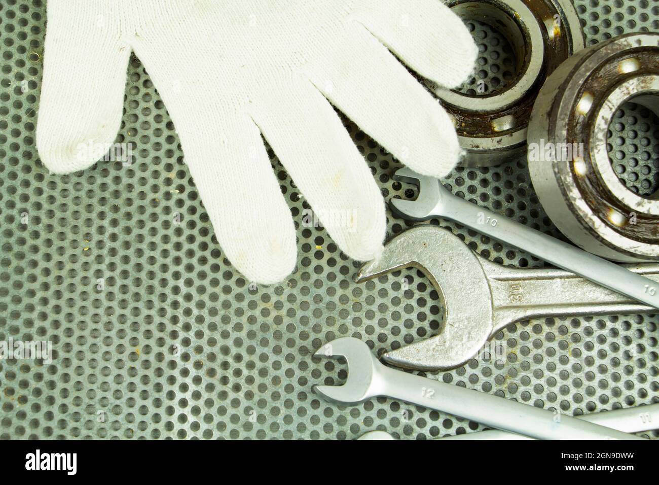 Replacement of the bearing, steel parts, a wrench, on the background of ...