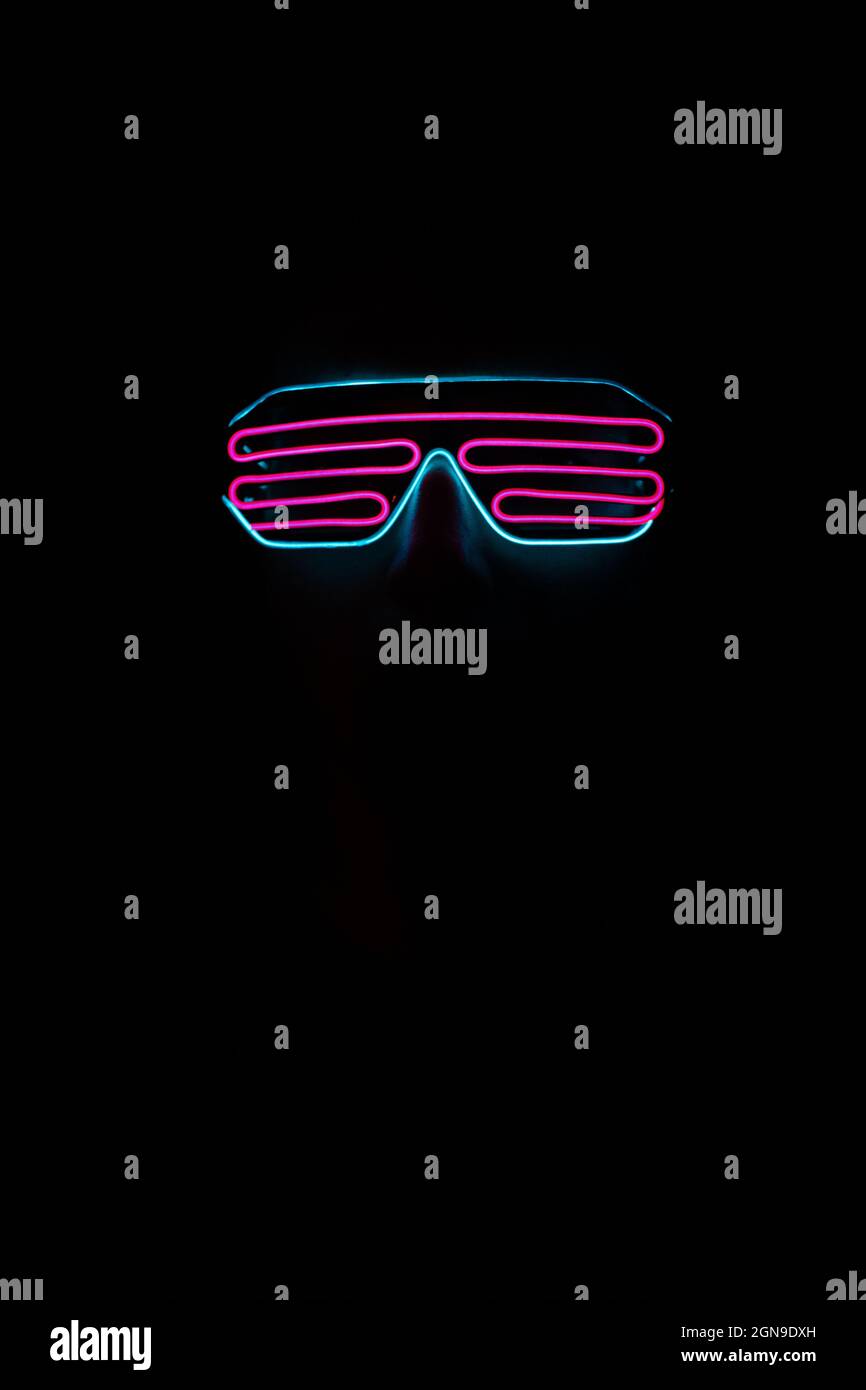 Closeup of colorful neon shutter glasses on black background with space ...