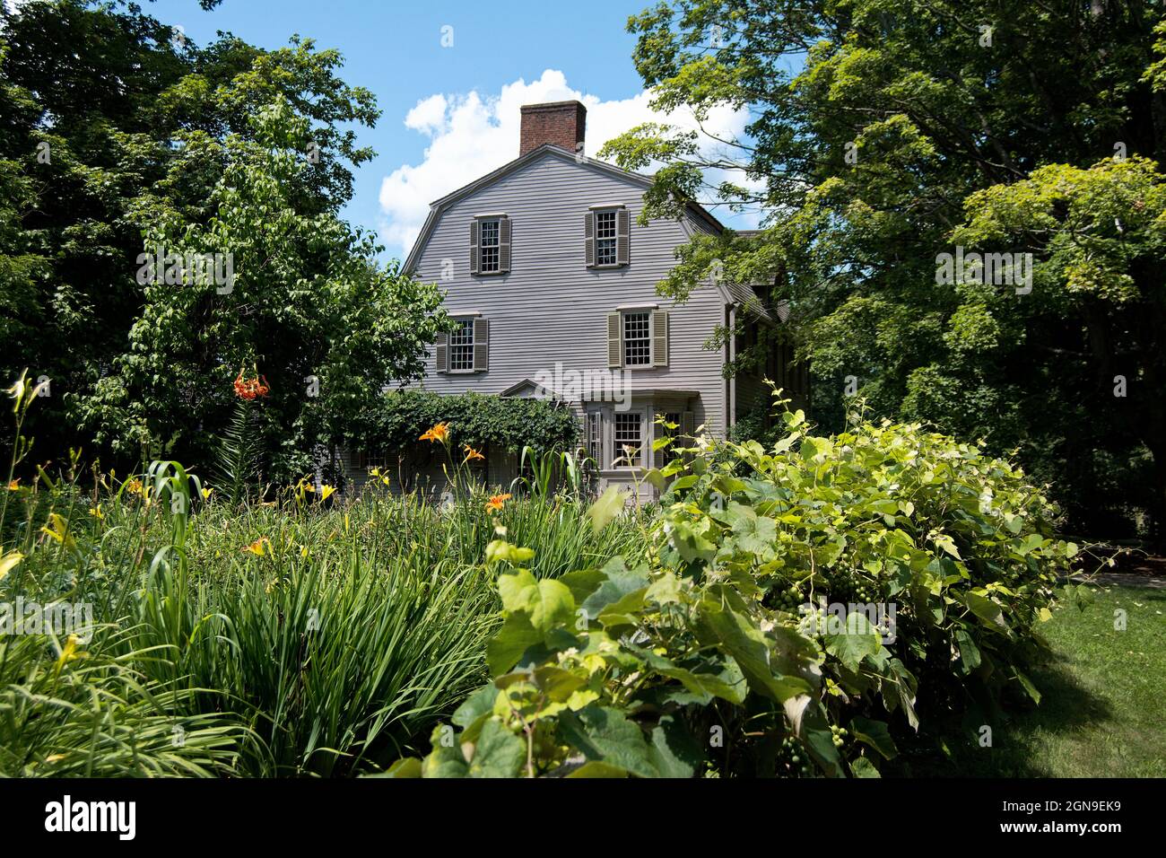 Side view of the historic Old Manse house with rich blooming garden in ...