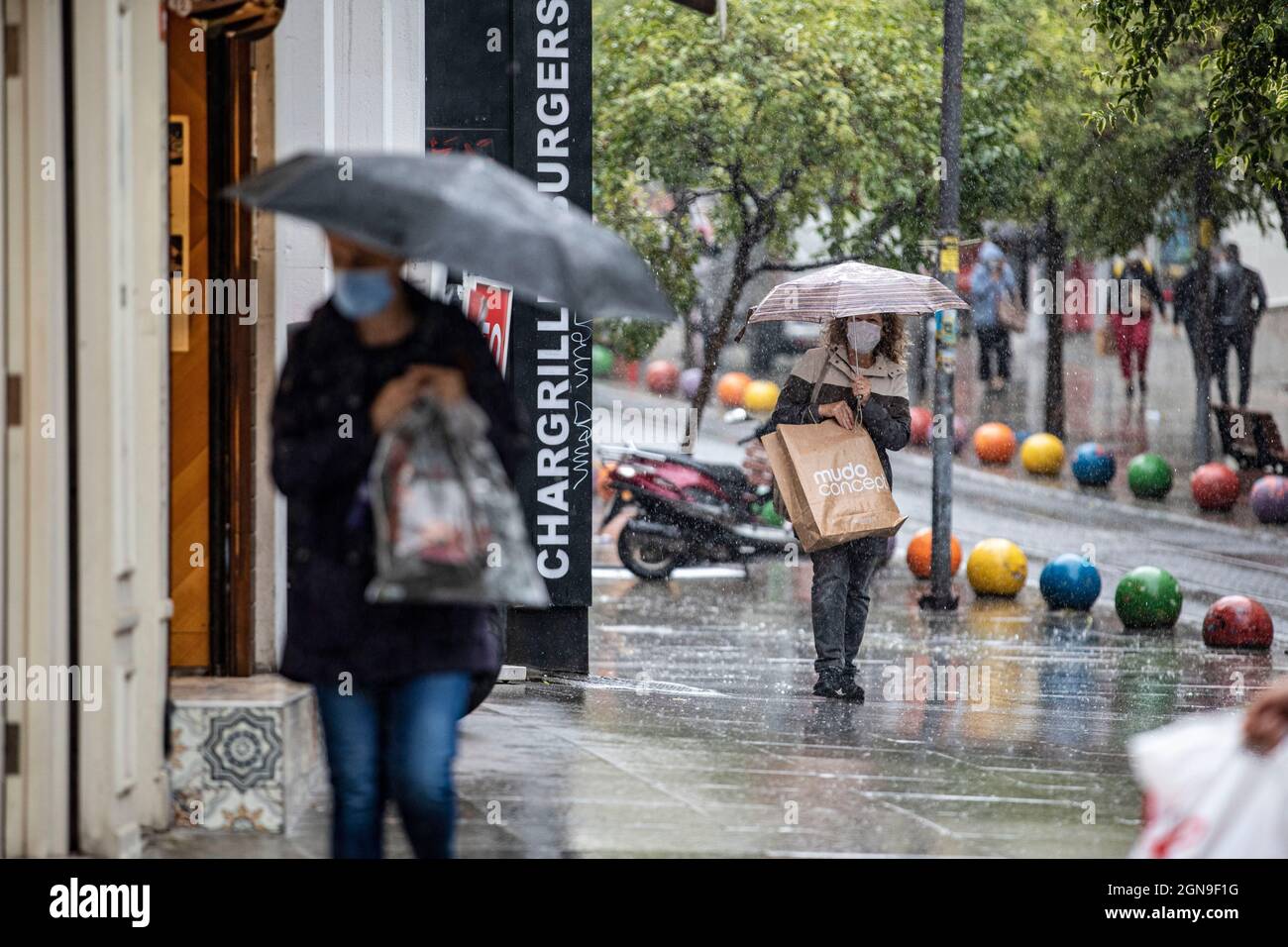 People seen carrying umbrellas to protect themselves from the rain on ...