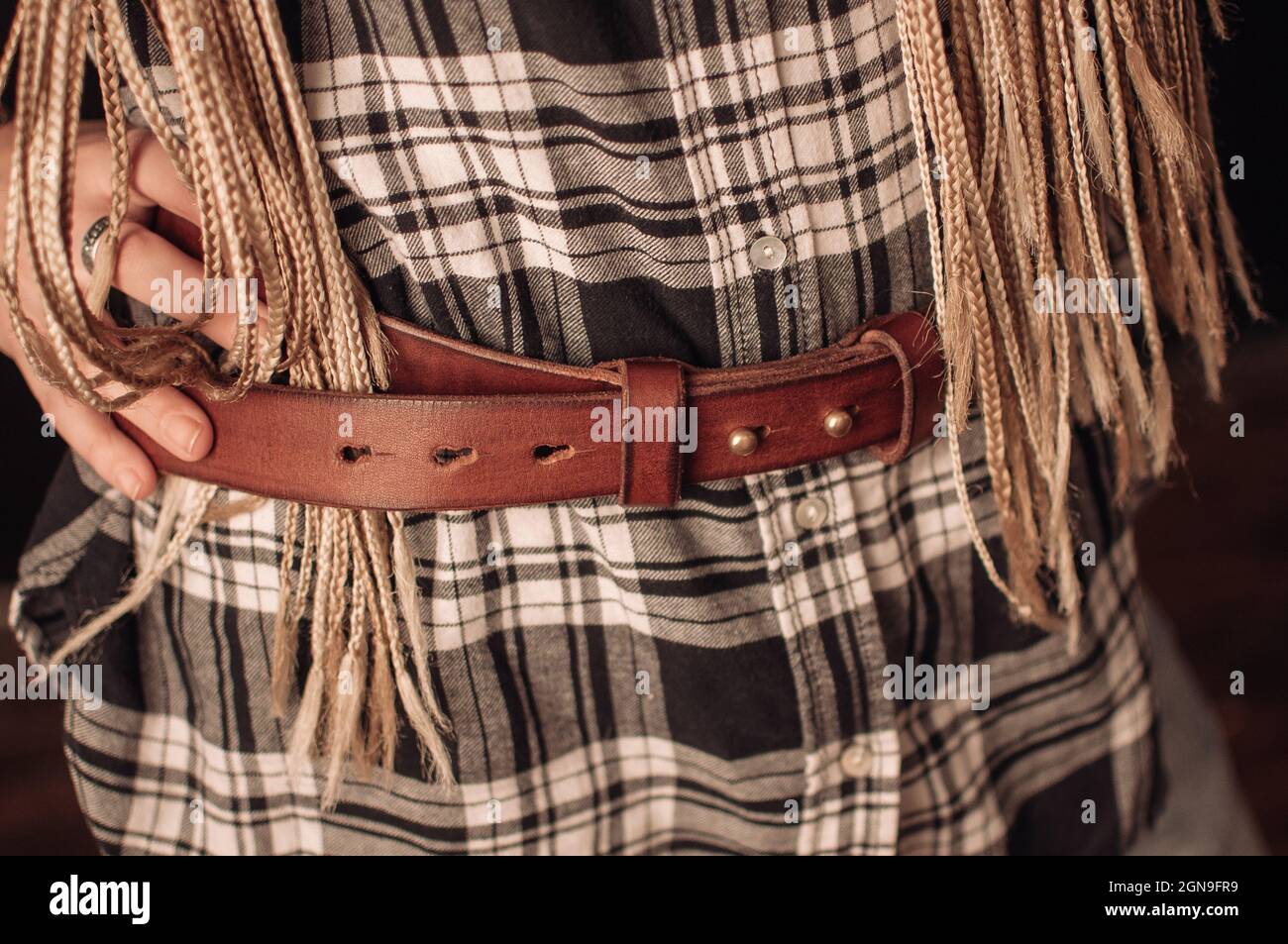 Person wearing an old leather belt Stock Photo - Alamy