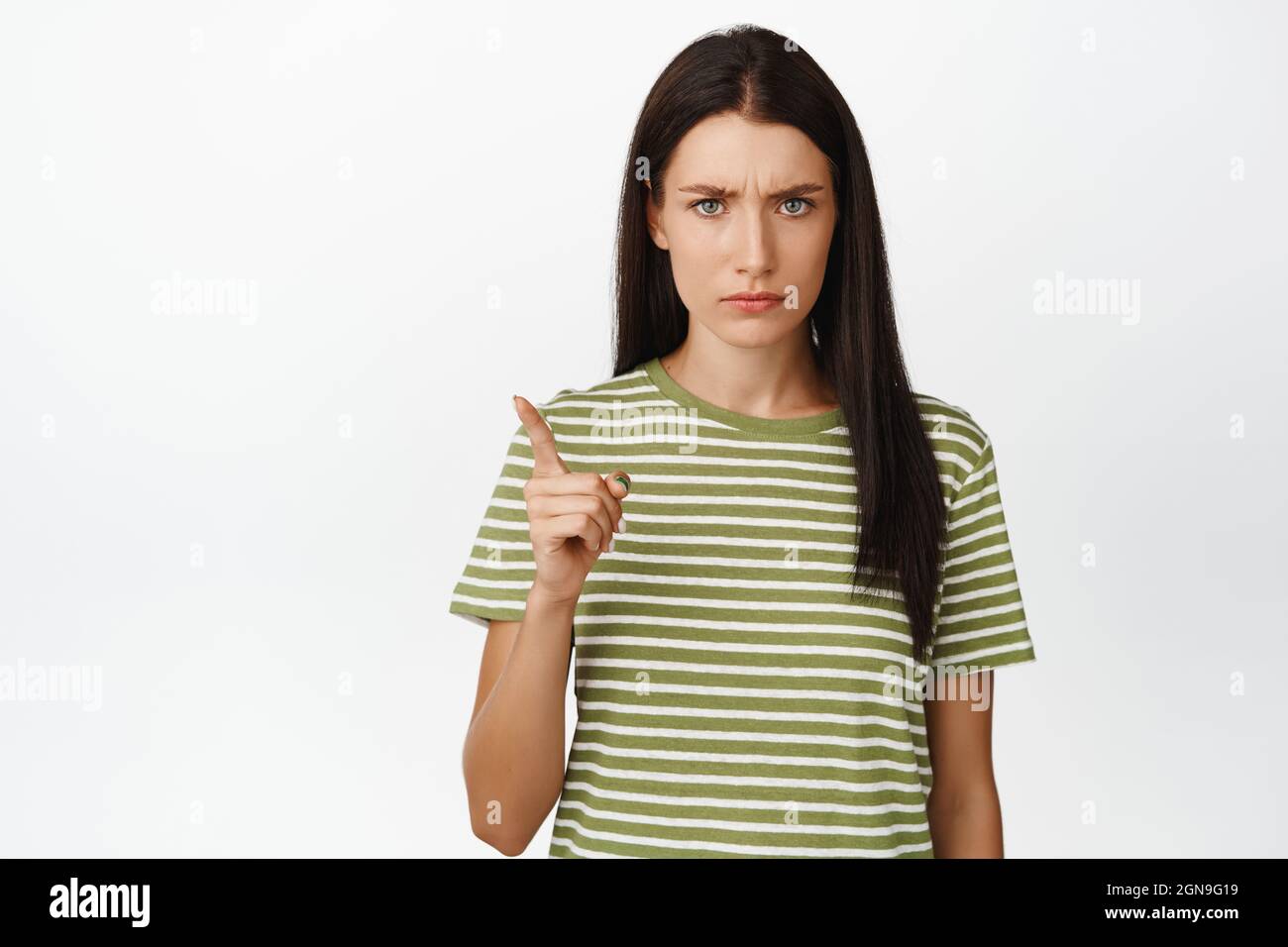 Angry brunette woman shaking finger in disapproval, scolding bad ...