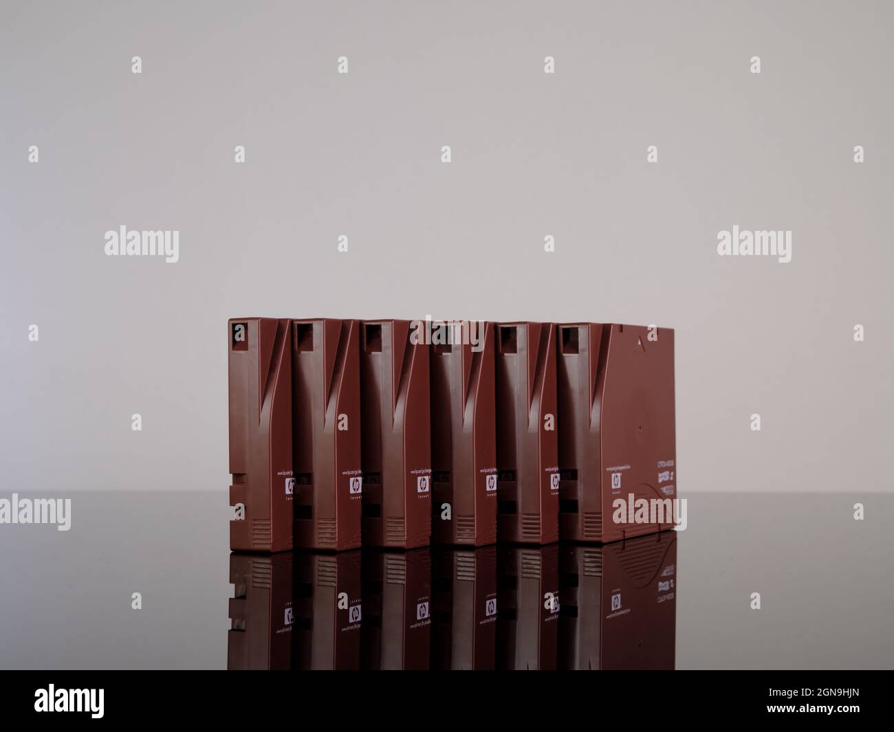 A row of magnetic LTO (Linear Tape Open) tape cartridges. LTO tapes are ...