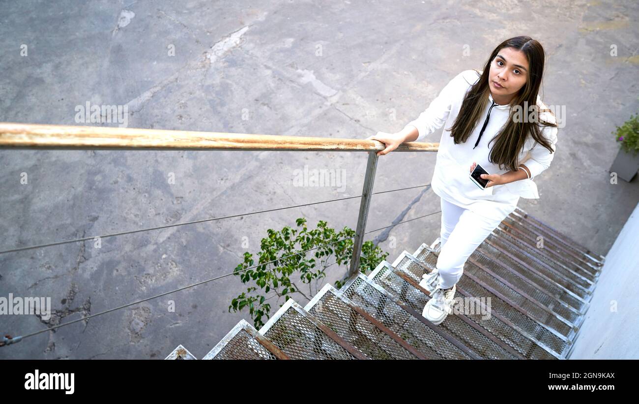 Beautiful woman ascending stairs Stock Photo - Alamy