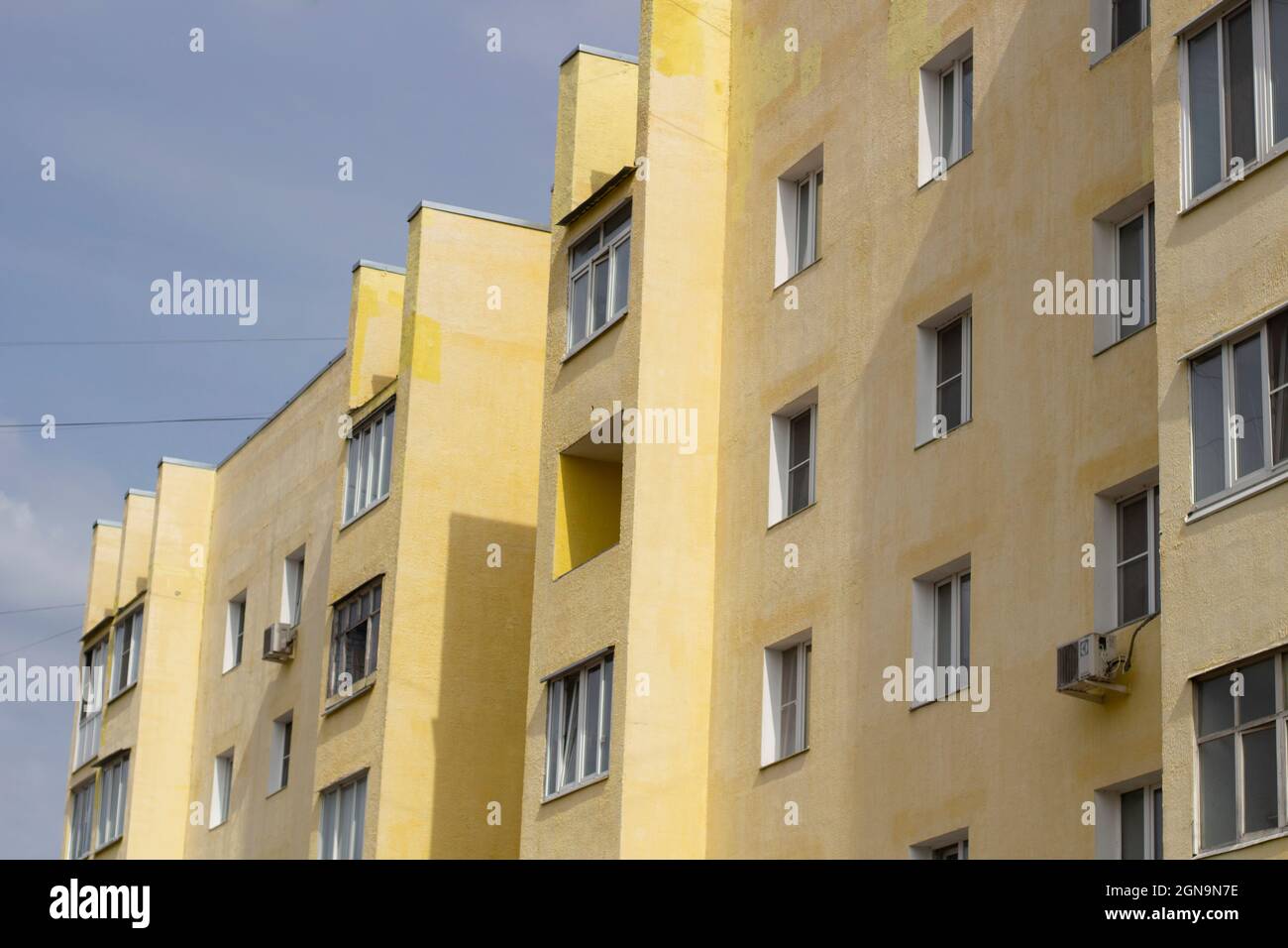 The windows in the house. An apartment building on the street. An ...