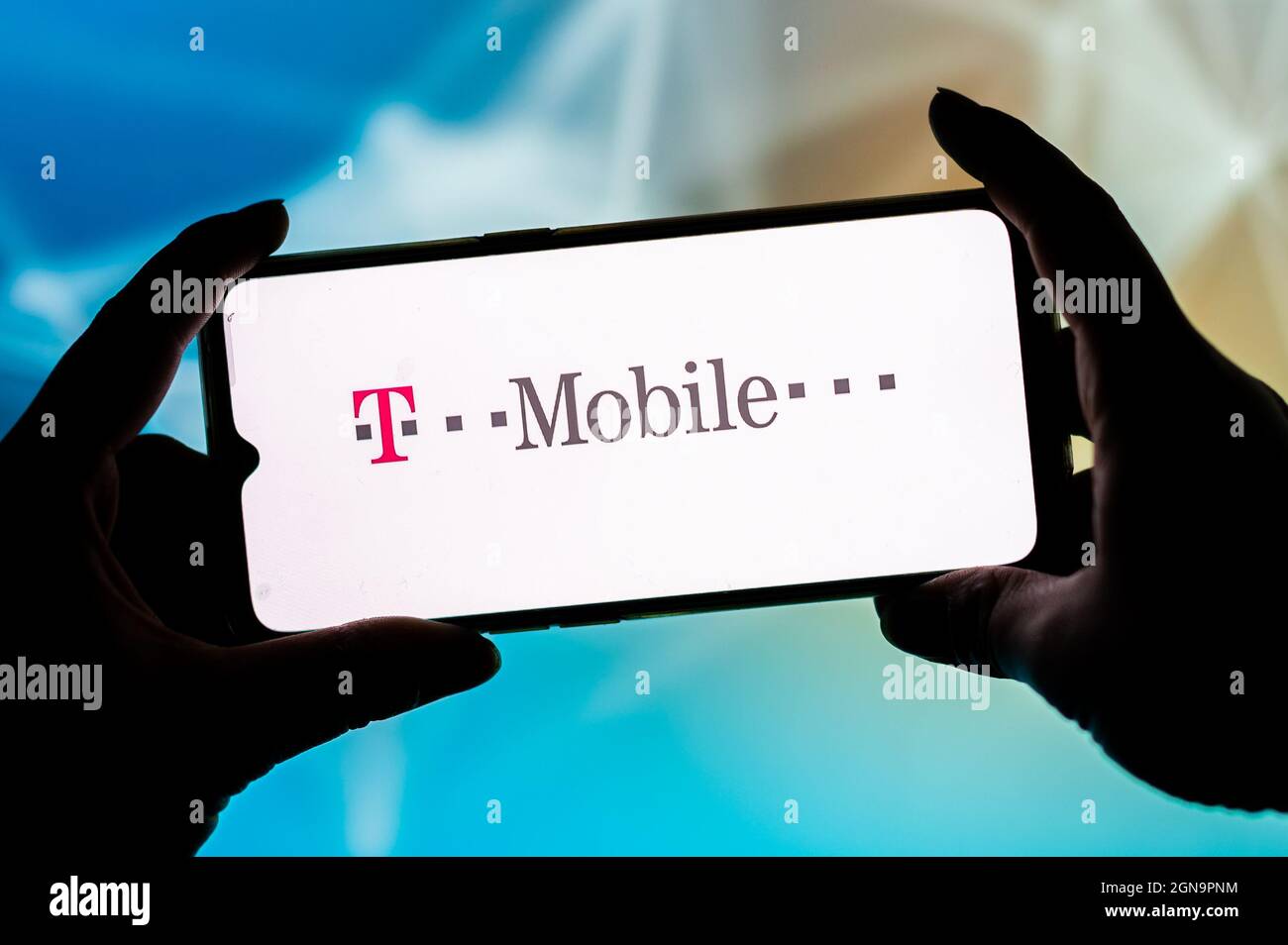 In this photo illustration a T-Mobile logo seen displayed on a ...