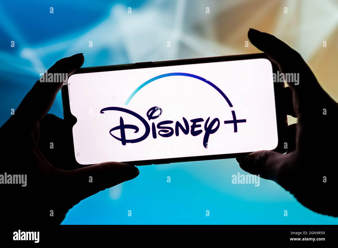 In this photo illustration a Disney Plus logo seen displayed on a ...