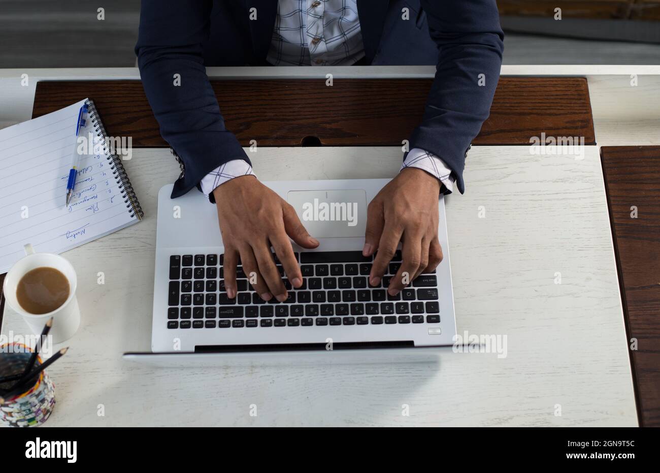 Adult corporate employee working on his laptop on a desk Stock Photo ...