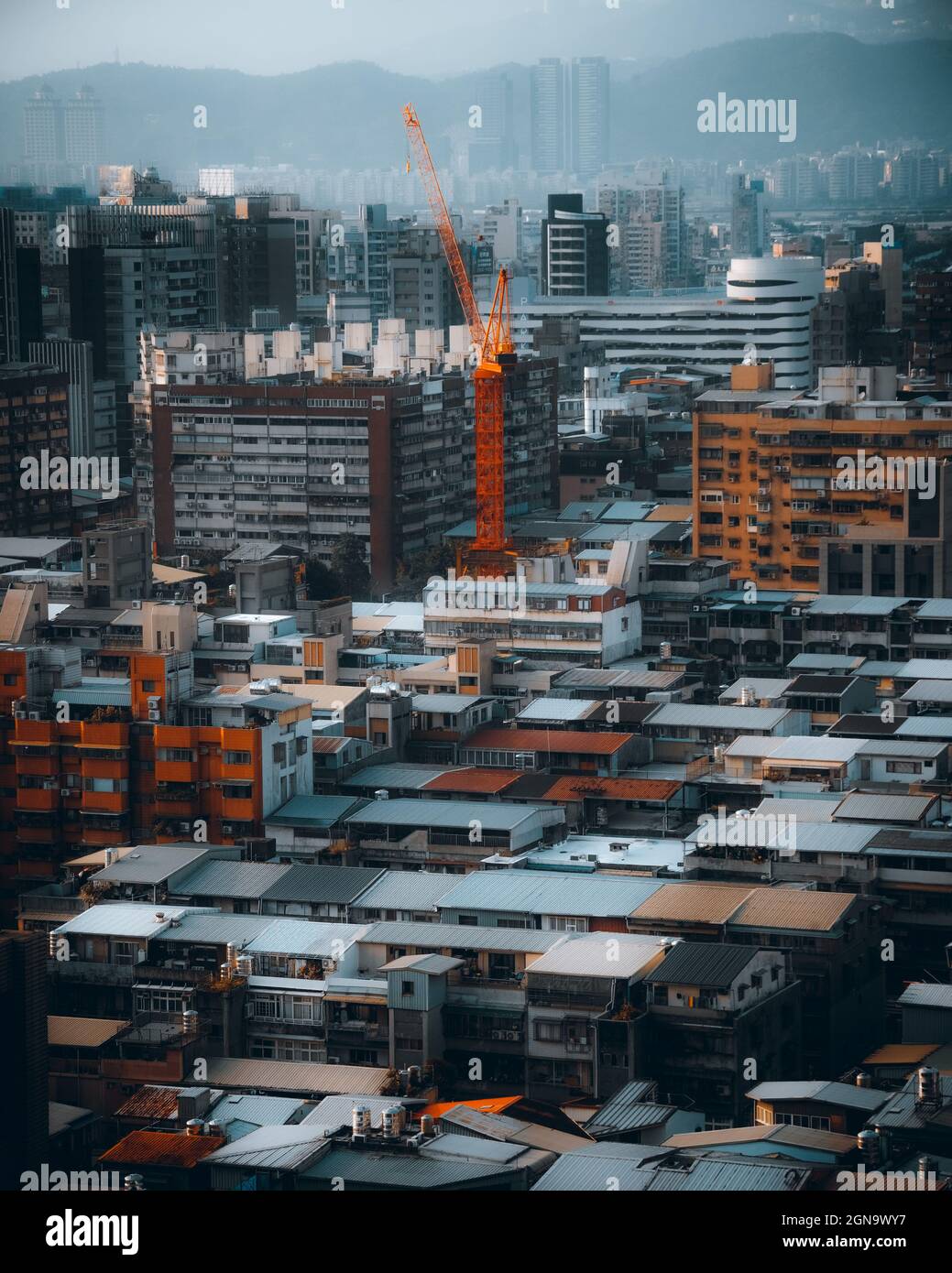 Urban scenery of construction tower crane between buildings Stock Photo ...