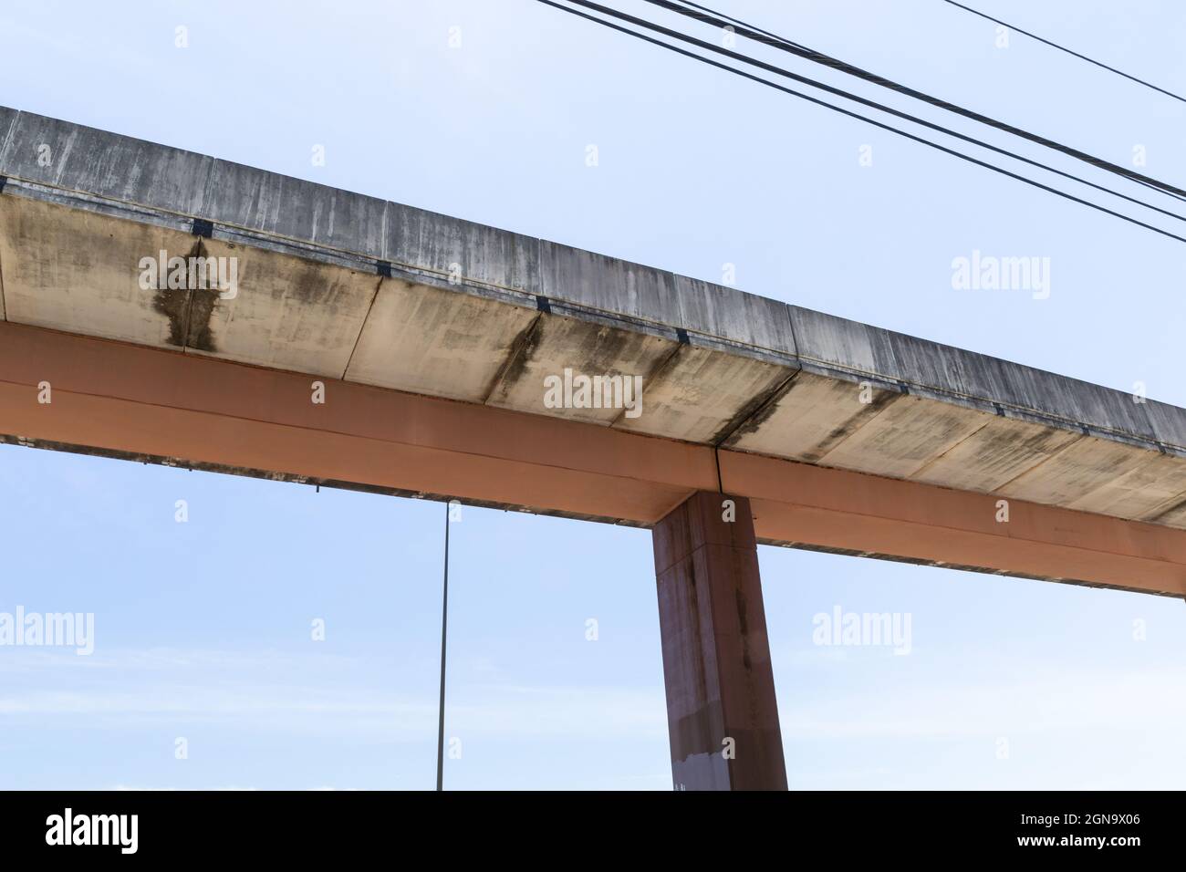 Elevated street, concrete sections atop an orange central support, dark ...