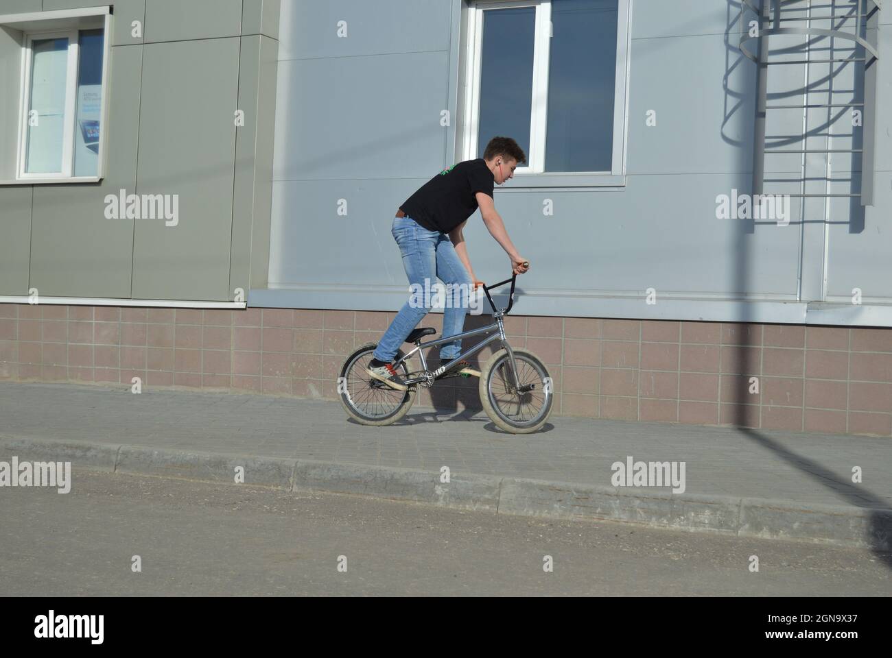 Kovrov, Russia. 9 April 2017. Teen on BMX bike near the shopping center Rus Stock Photo - Alamy