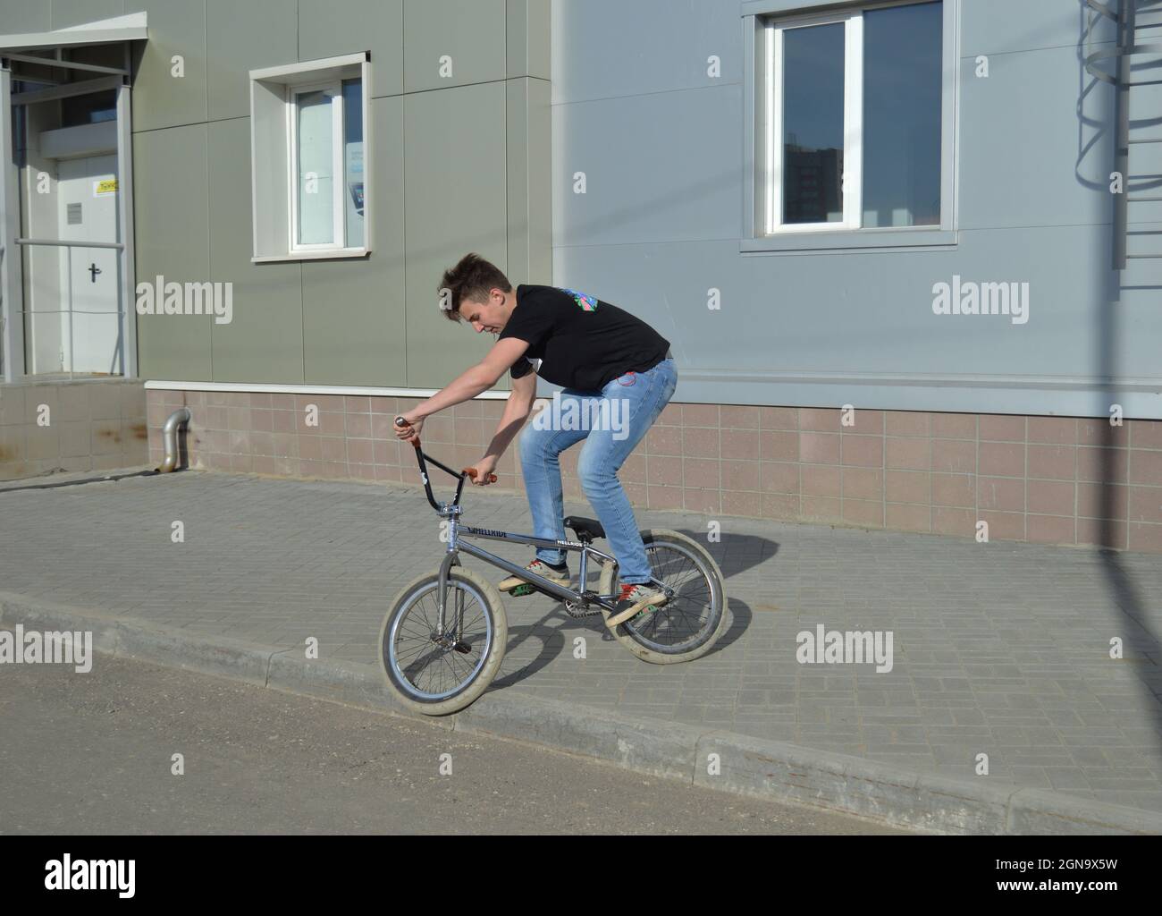Kovrov, Russia. 9 April 2017. Teen on BMX bike performs a trick near the shopping center Rus ...