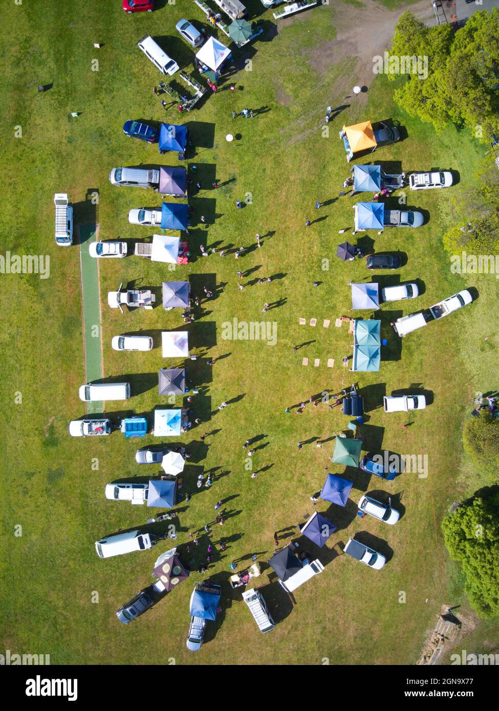Outdoor market stalls aerial view with traders, people interacting ...