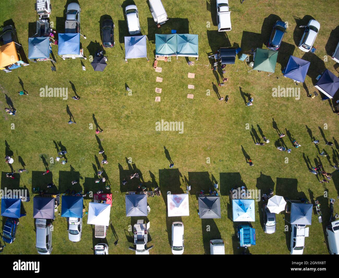 Outdoor market stalls aerial view with traders, people interacting ...