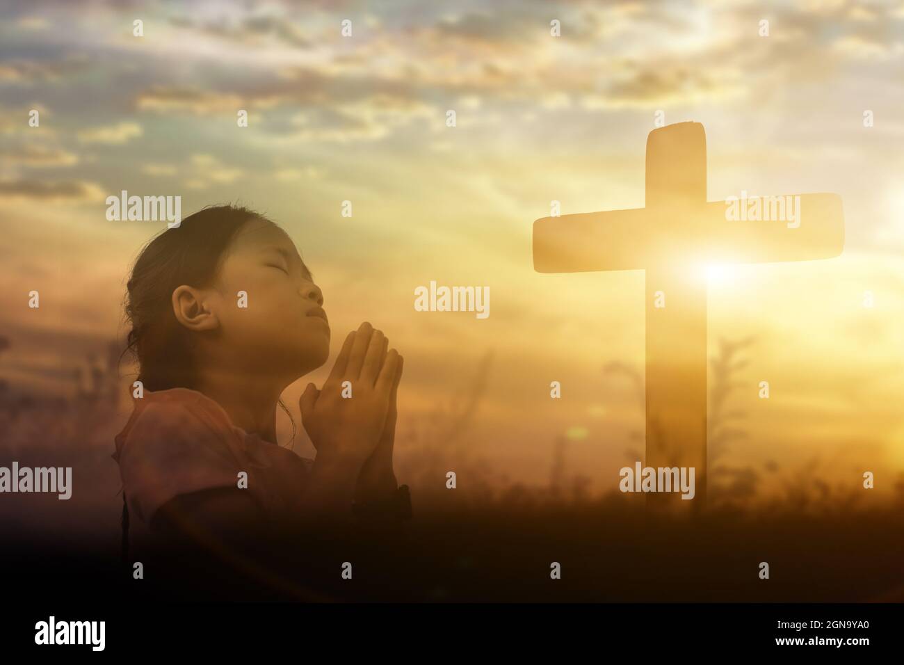 Young Girl Raising Hands Worship And Praise God At Sunset Background