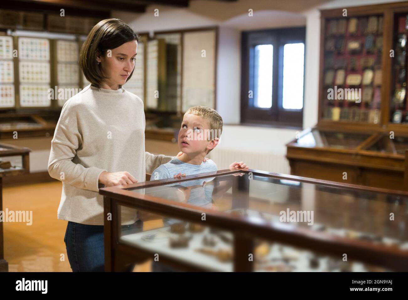 Woman and boy exploring artworks in museum Stock Photo - Alamy