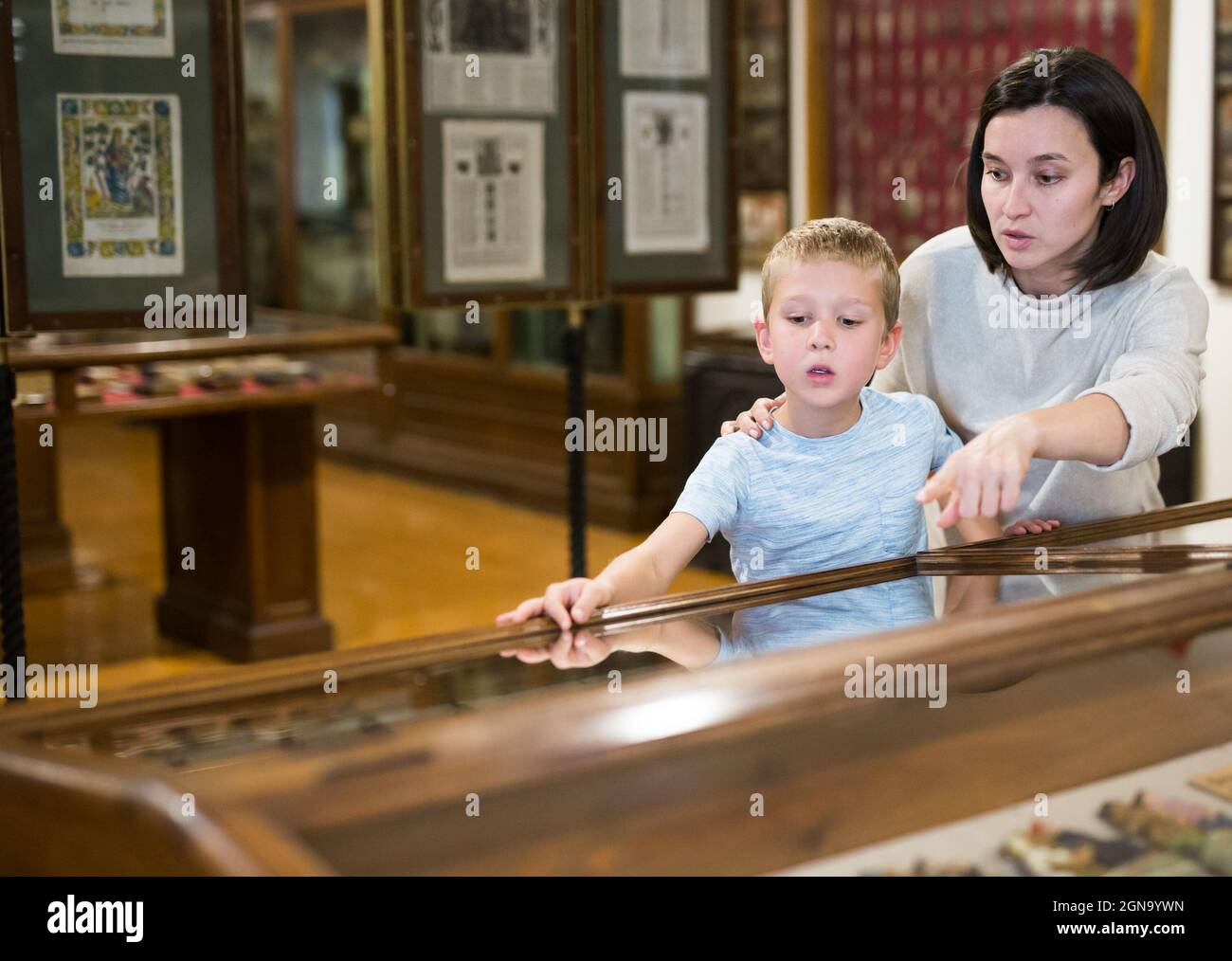 Woman and boy exploring artworks in museum Stock Photo - Alamy