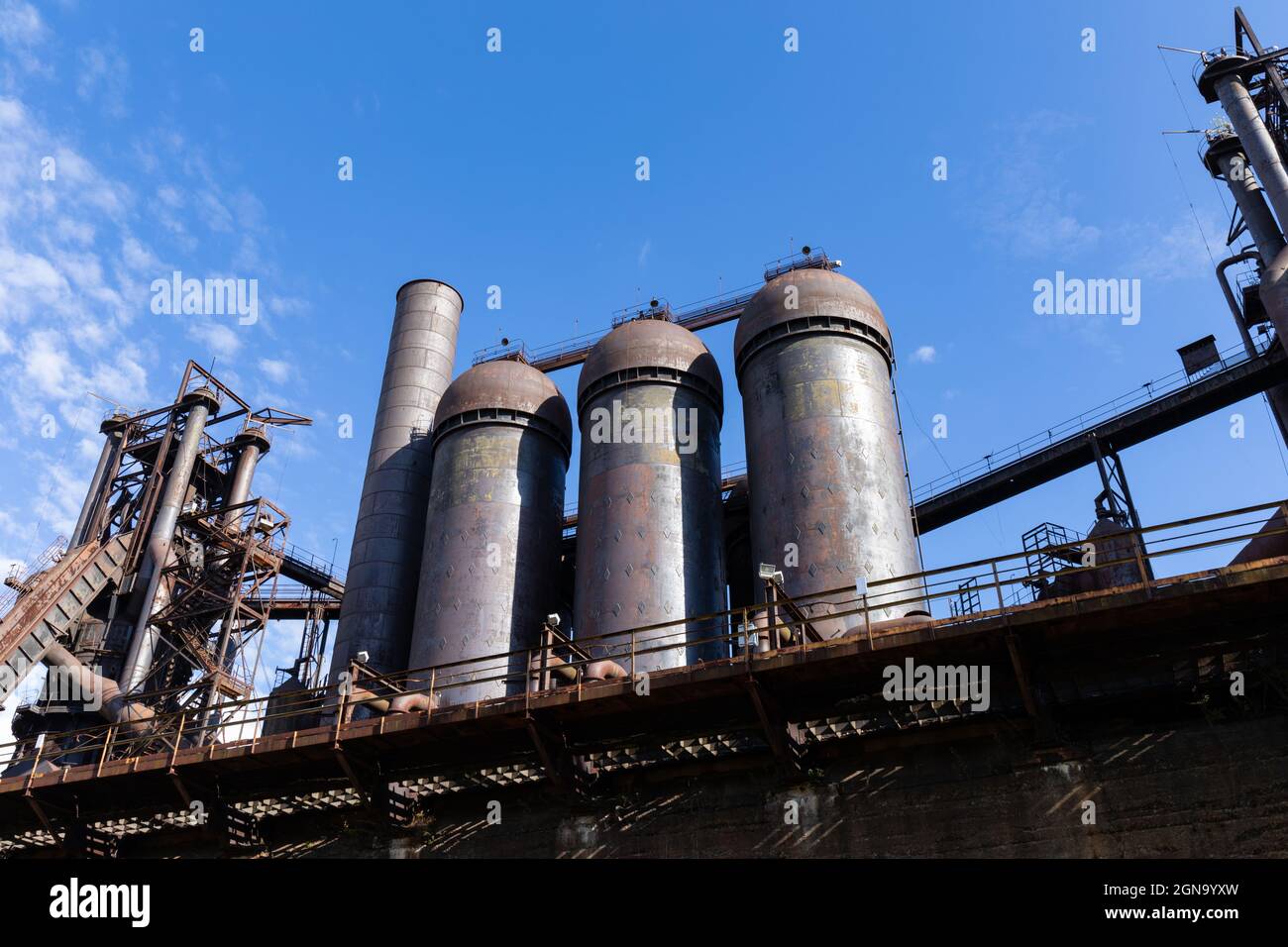 Huge metal blast furnaces of an industrial steel mill, beautiful blue ...